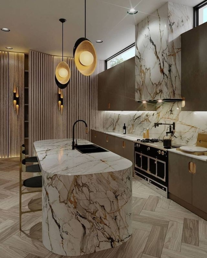 KITCHEN WITH A COMBINATION OF MARBLE AND SOME GOLD ACCENTS
